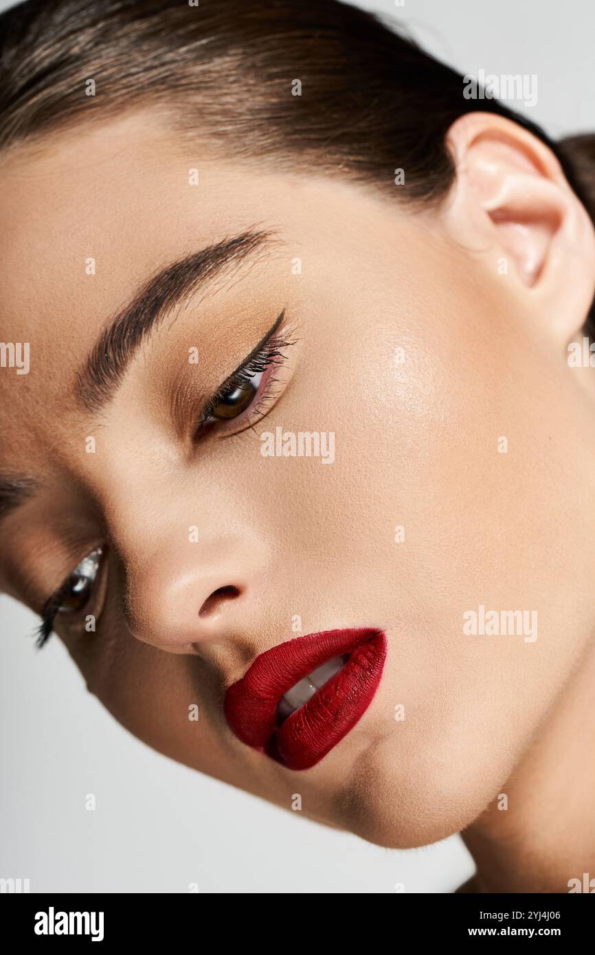 A stunning woman with bold red lips showcases her captivating features ...