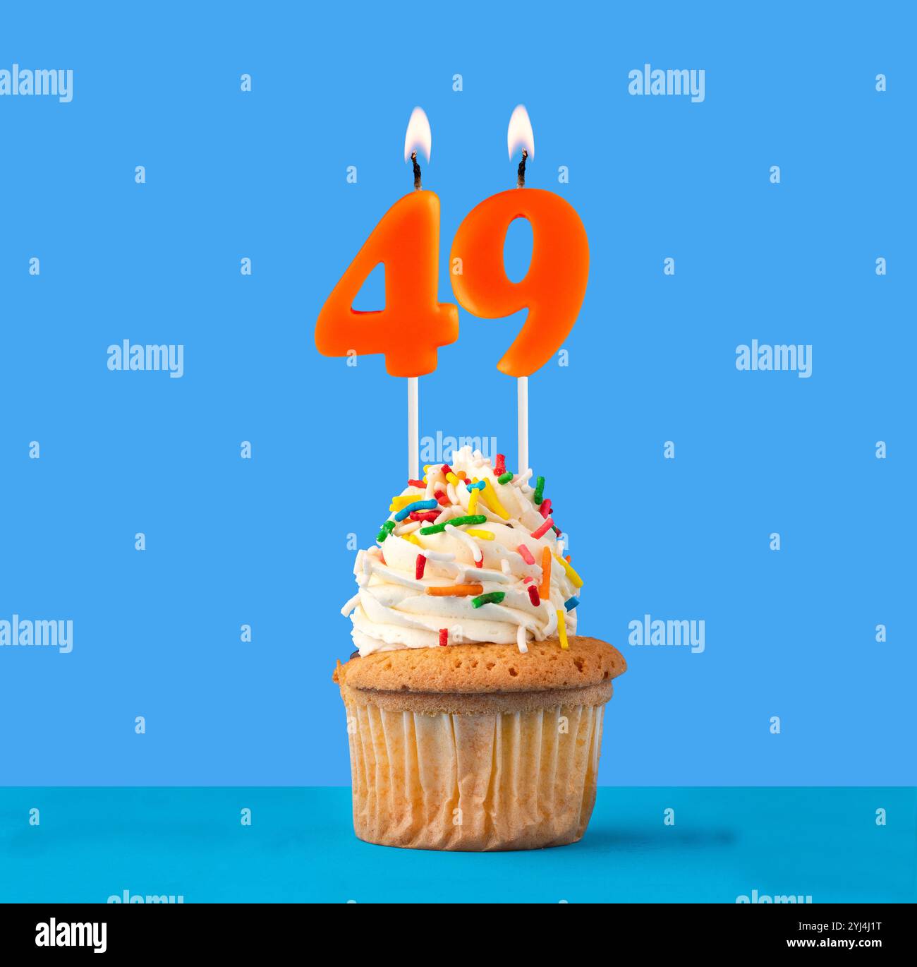 Orange birthday candle and cupcake - Number 49 Stock Photo - Alamy