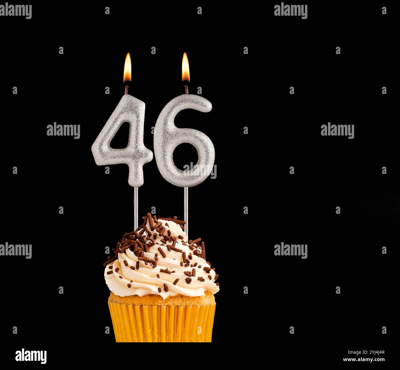 Number 46 shaped candles - Birthday cupcake on black background Stock ...