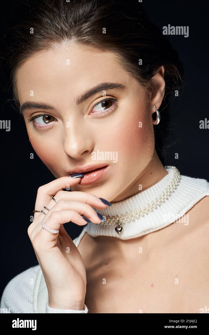 A striking woman poses gracefully with an elegant expression and ...