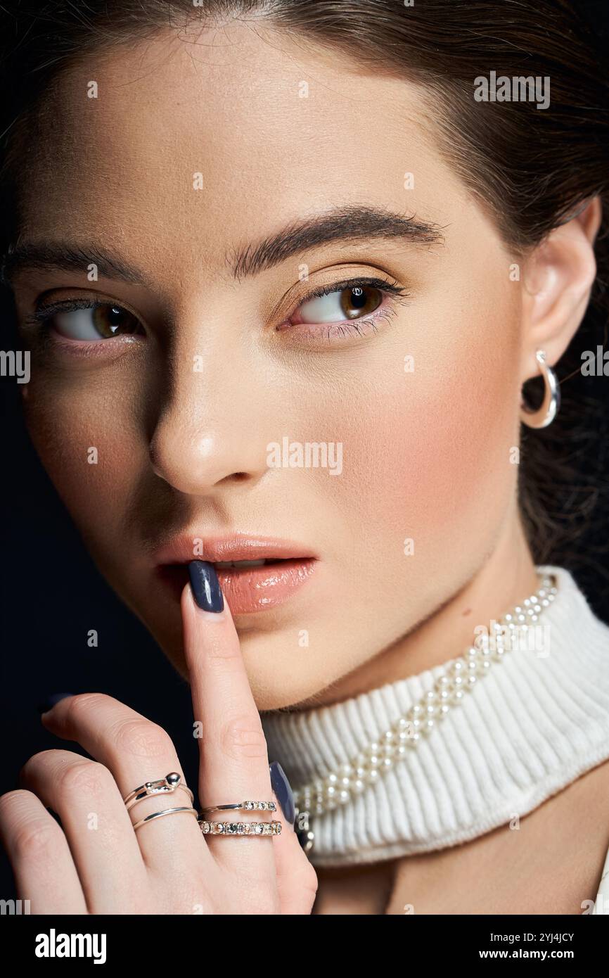 A woman with striking features poses quietly, revealing a sense of ...