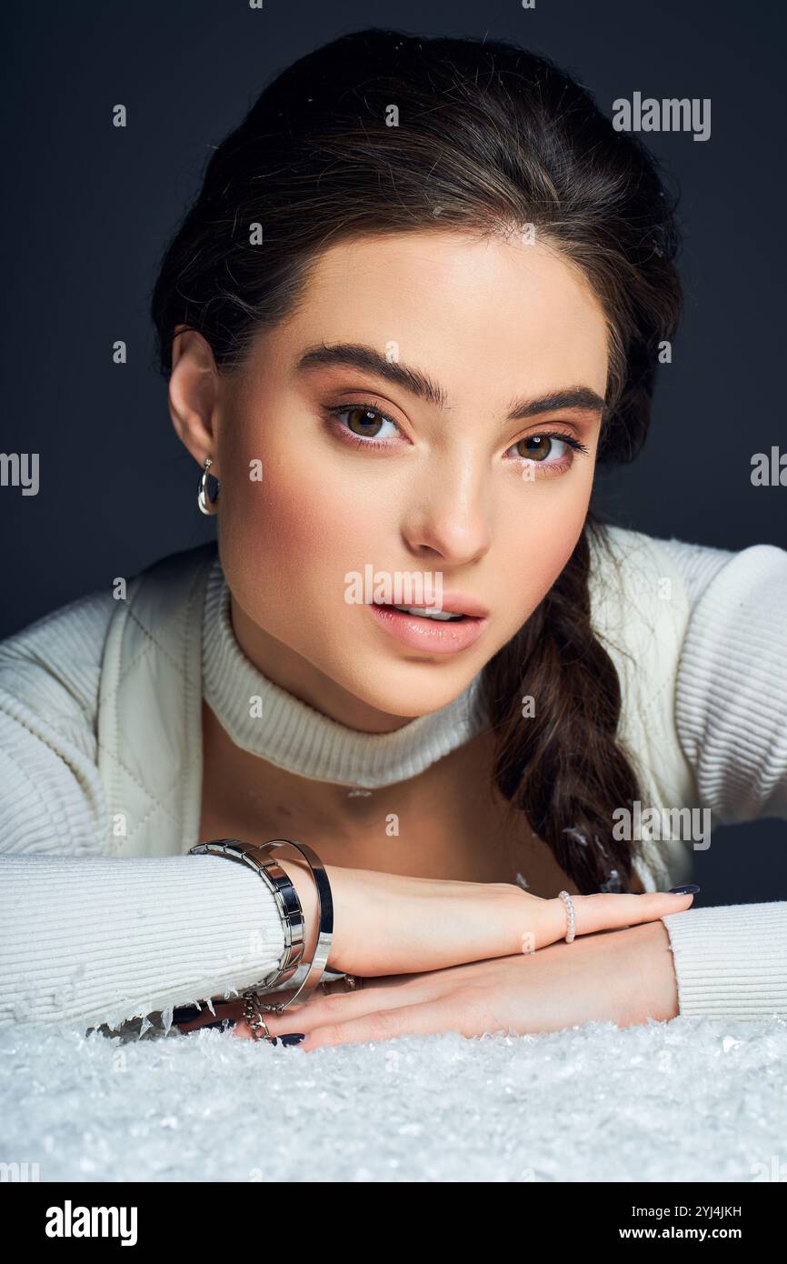 Soft light accentuates her features as she leans forward with a ...