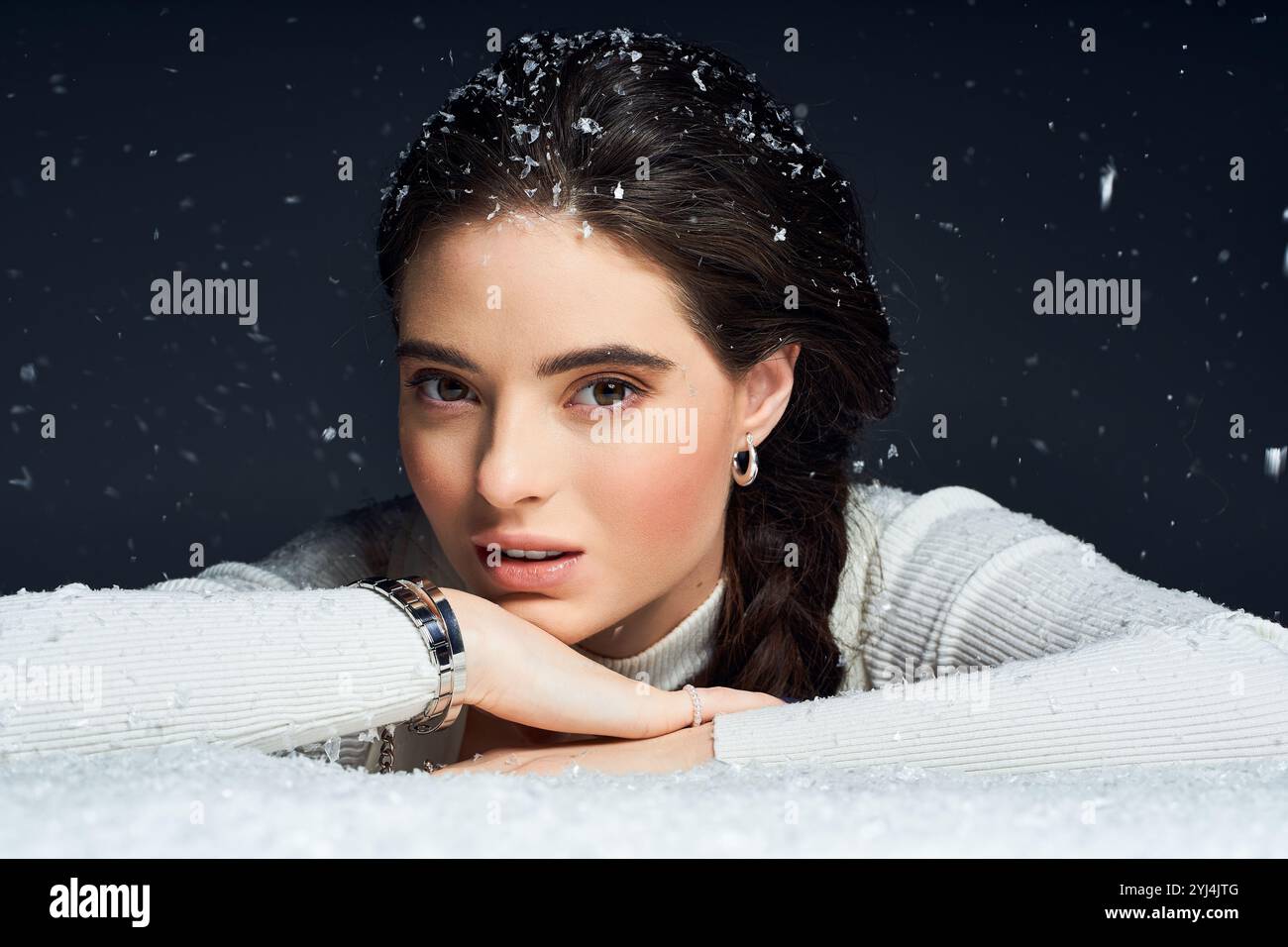 A lovely woman enjoys the beauty of winter while embracing delicate ...