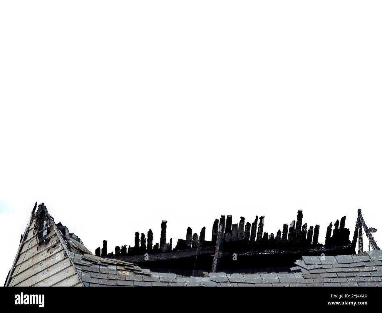 Fire damaged roof with blackened wooden beams isolated against a white ...