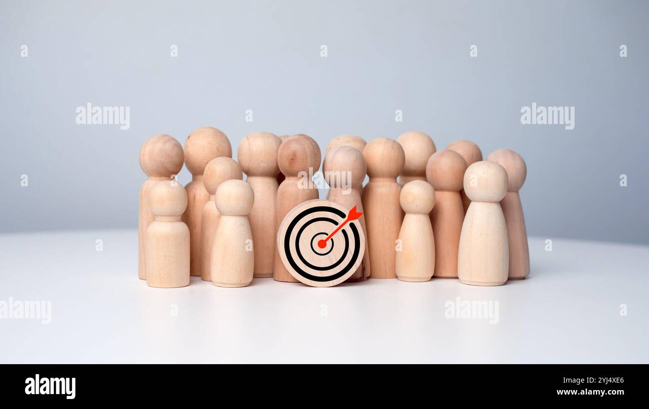 Wooden dolls standing around dart board for creating and targeting ...