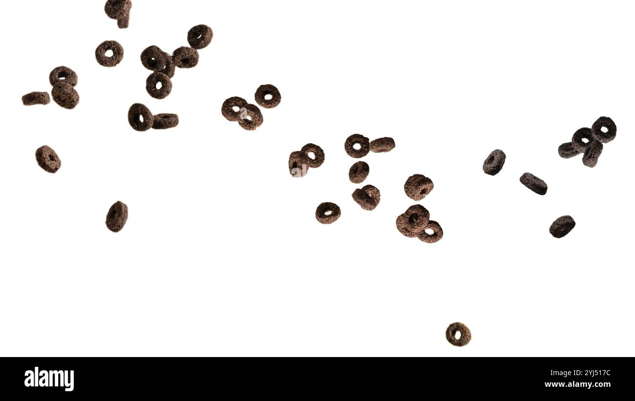 Chocolate rings cereal spill out into a bowl. Breakfast. Isolated on a ...