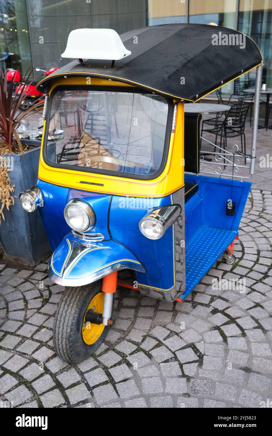 Blue three wheel car in the city Stock Photo - Alamy