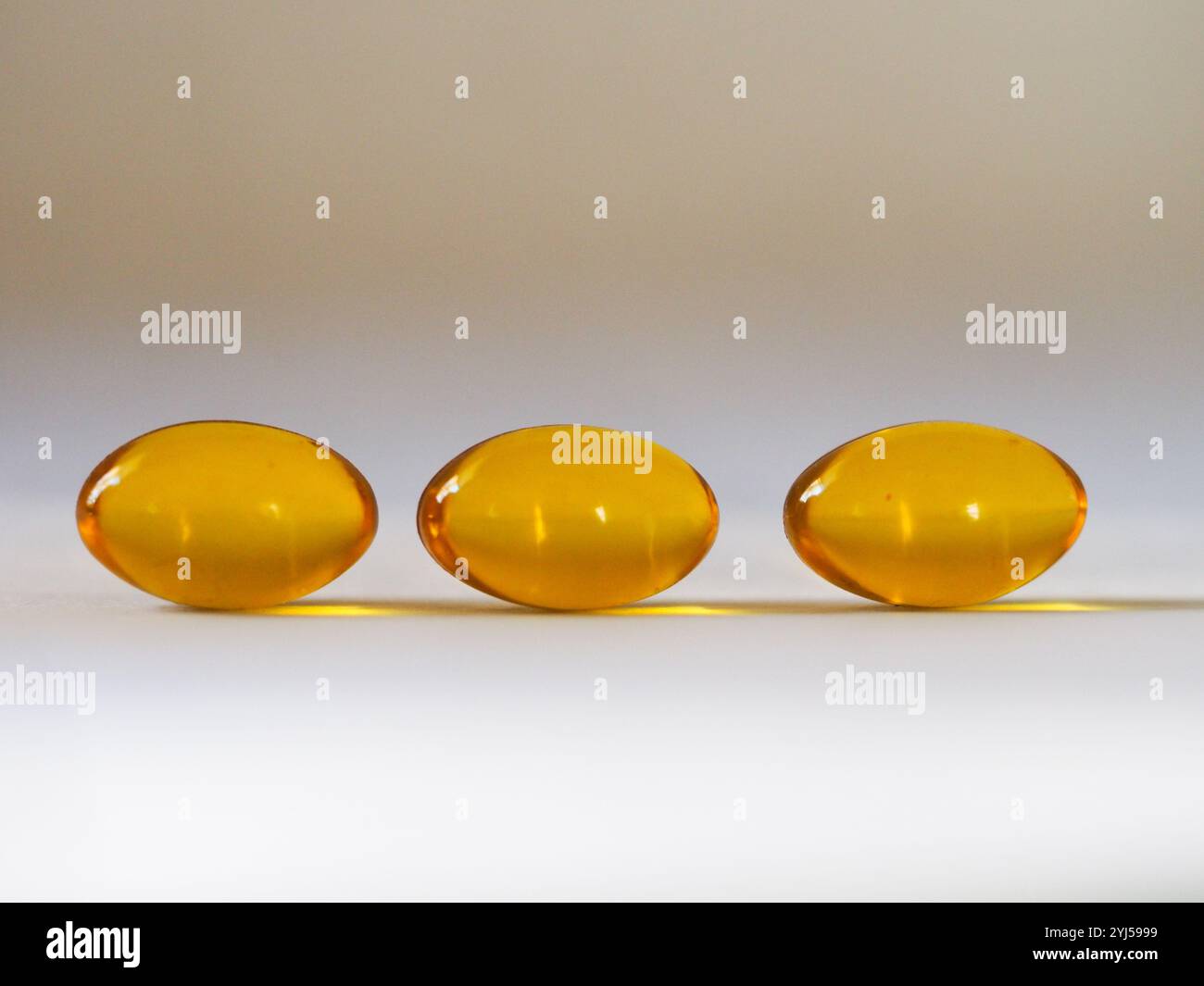 Three yellow medical pills Stock Photo - Alamy