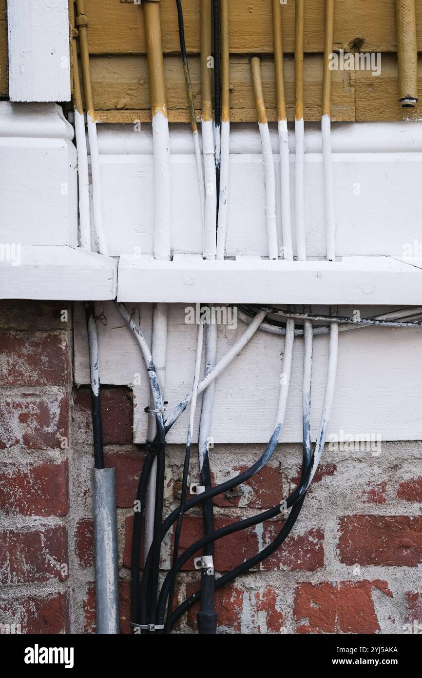 Cables on a building wall Stock Photo - Alamy
