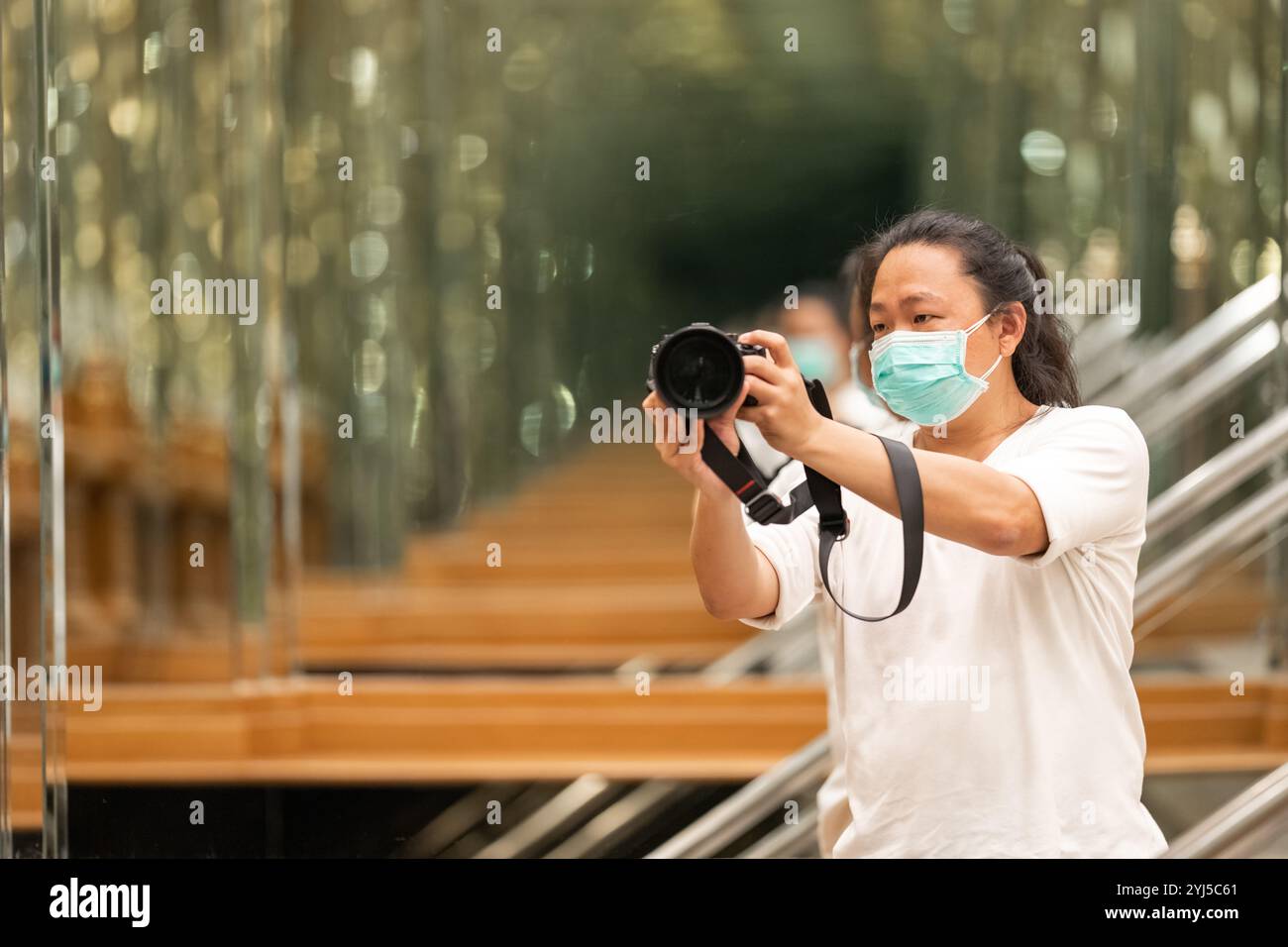 Photographer using camera to taking Self Portrait in the mirror ...