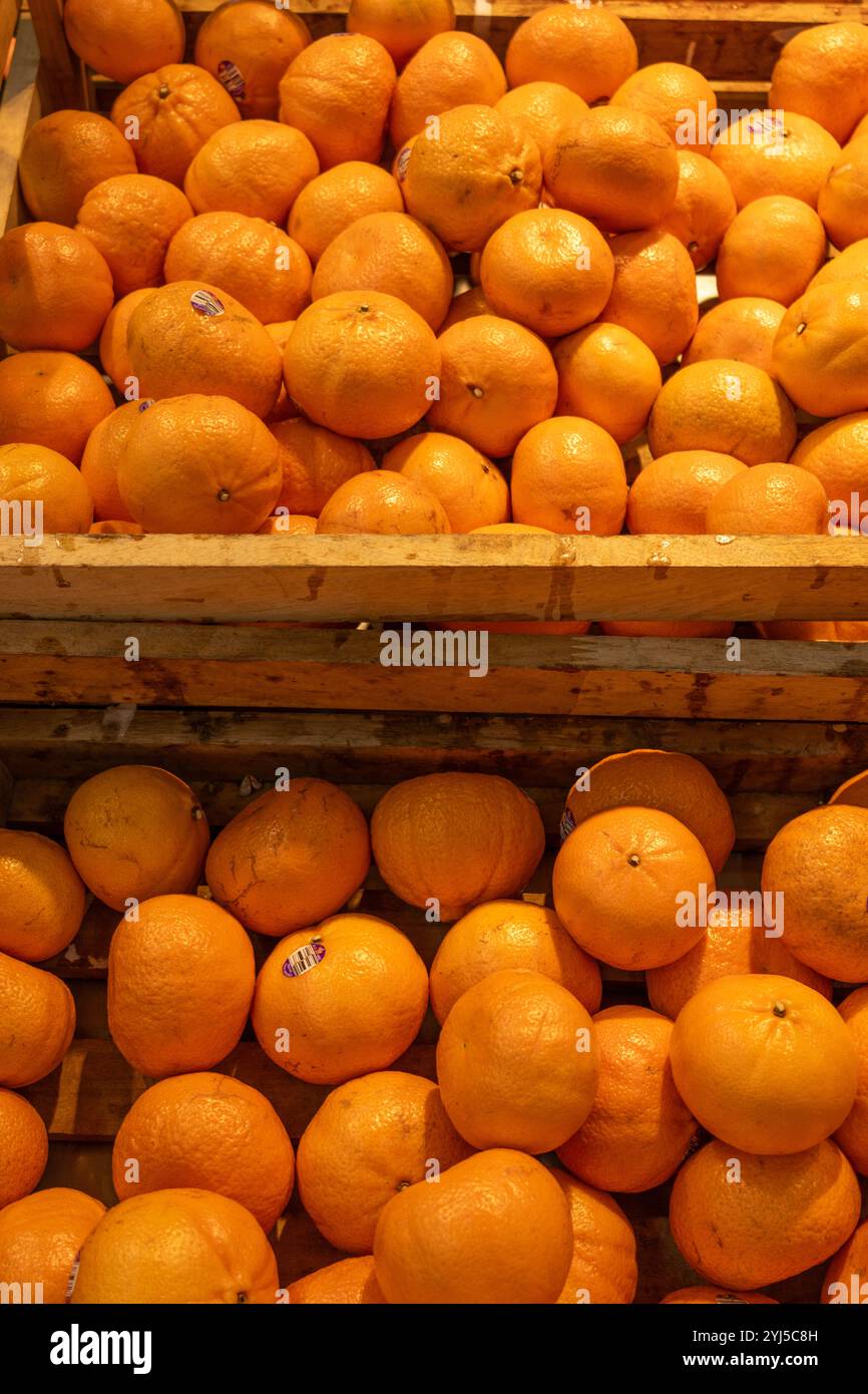 A pile of bright, fresh oranges stacked together, displaying vibrant ...