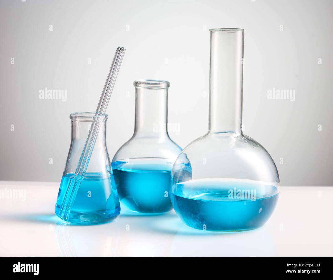 Laboratory equipment beakers and flask with backlight in different ...