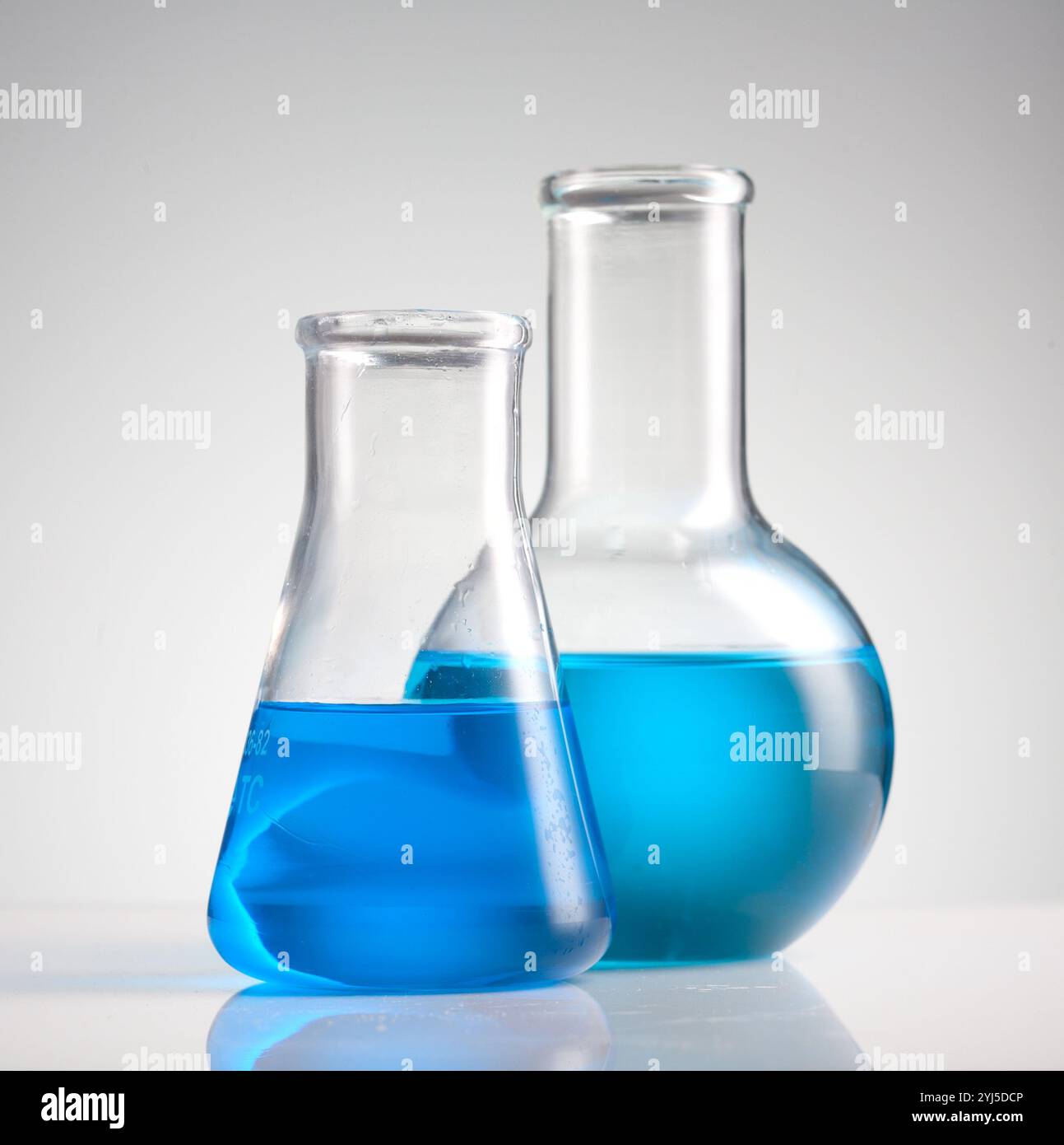 Laboratory equipment beakers and flask with backlight in different ...