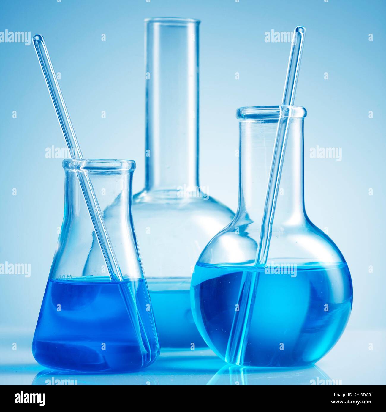 Laboratory equipment beakers and flask with backlight in different ...