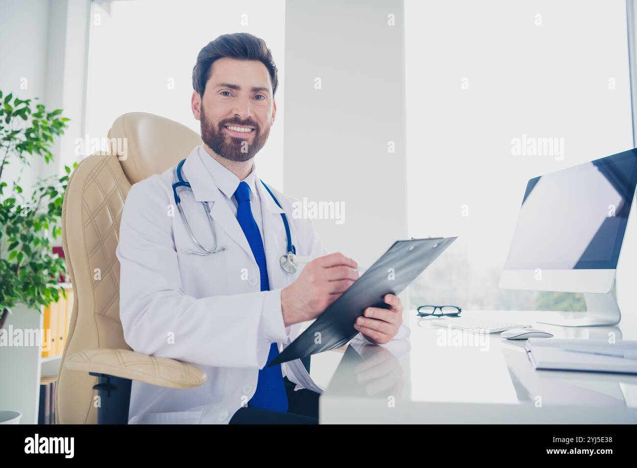 Photo of expert doctor guy sit desk writing check list consult online ...