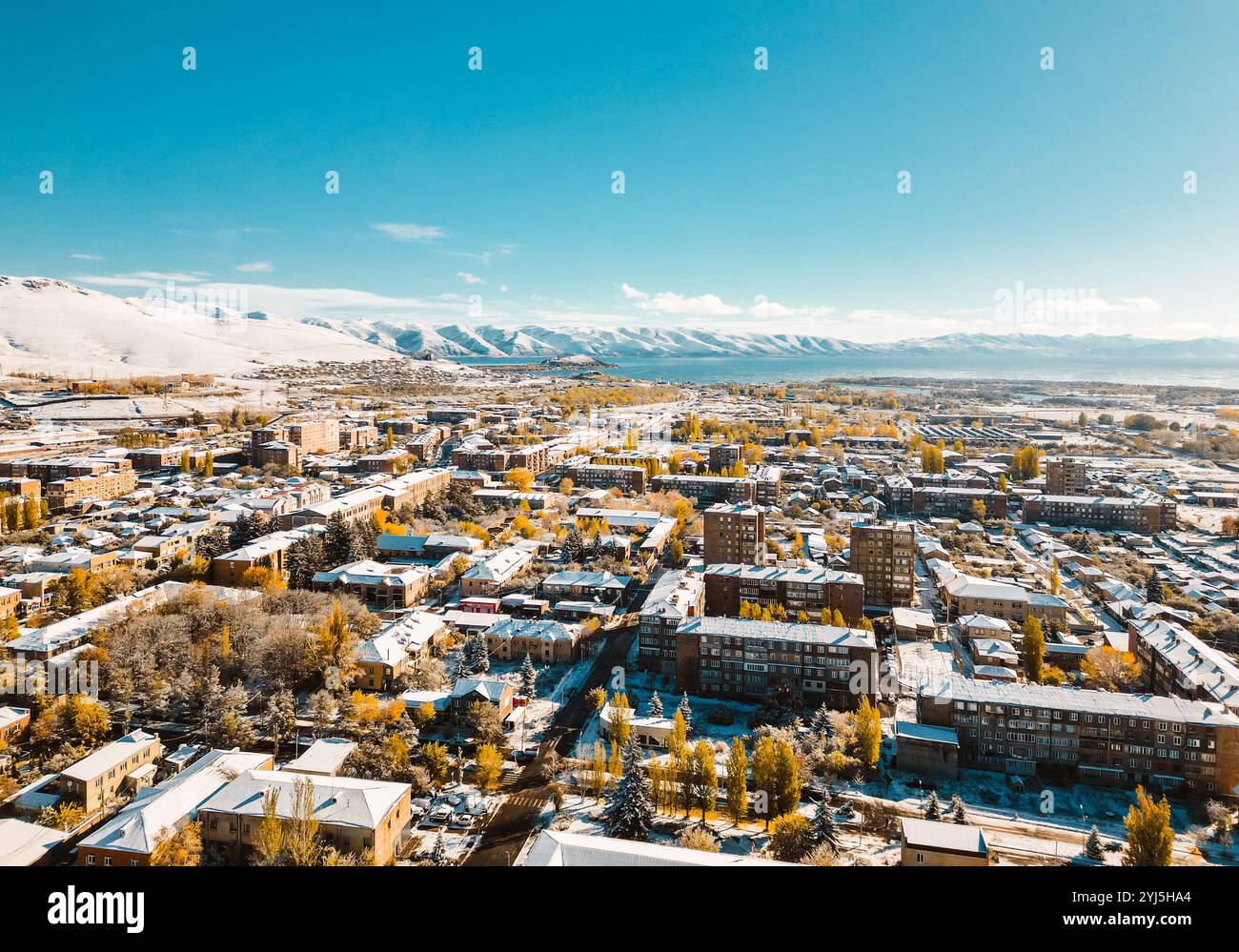 Aerial fly over view Sevan town and Lake Sevan. Famous Sevan lake ...