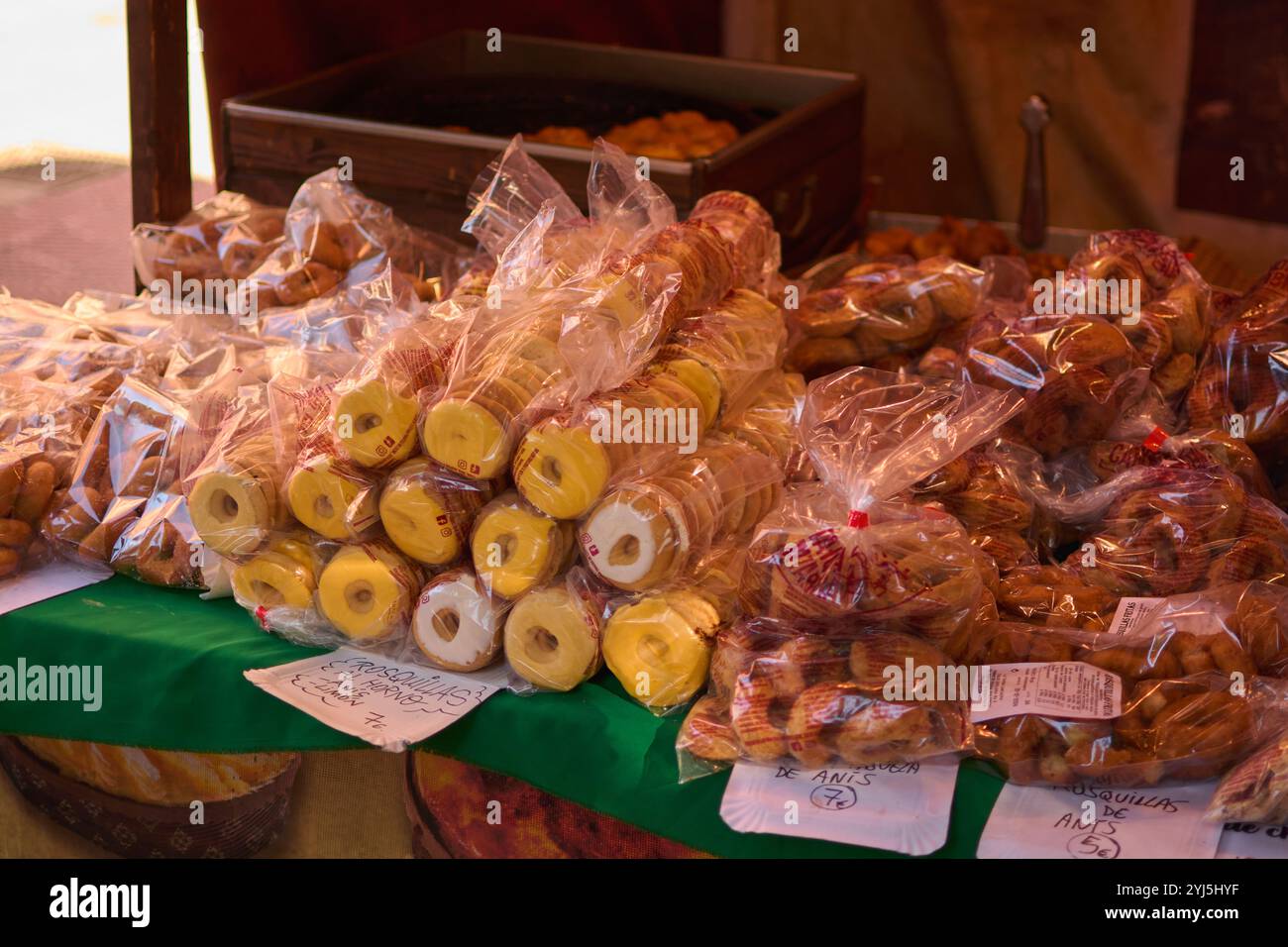 A market stall displaying a variety of freshly baked donuts in clear ...