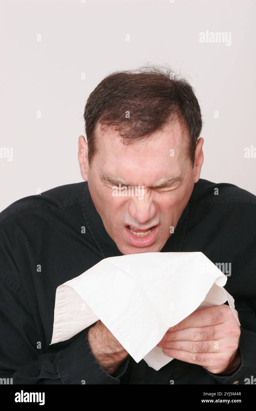 Middle-aged man, with dark hair on white background, makes unusual face ...