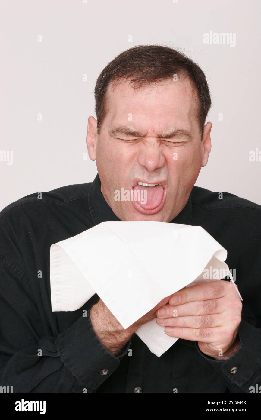 Middle-aged man, with dark hair on white background, makes unusual face ...
