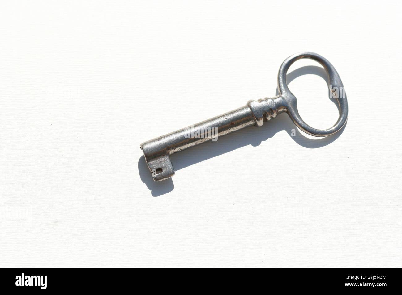 Antique key on a white background photographed in the studio ...