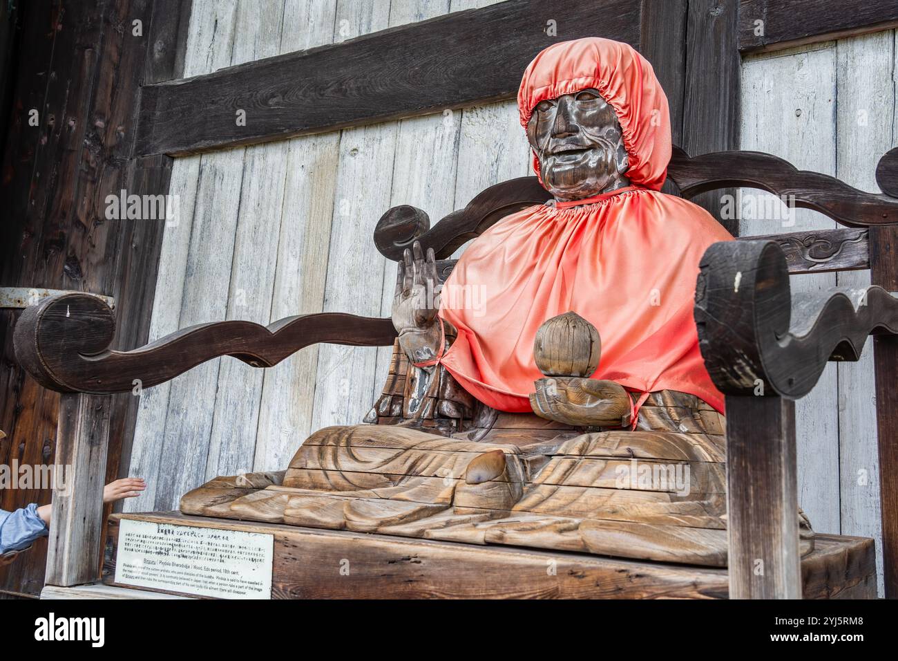 The wooden statue of Binzuru (Pindola Bharadvaja) at the entrance of ...
