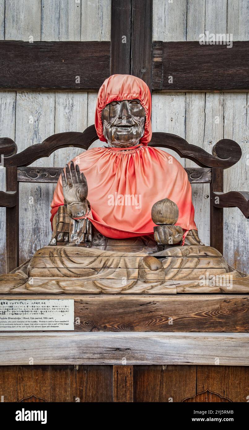 The wooden statue of Binzuru (Pindola Bharadvaja) at the entrance of ...