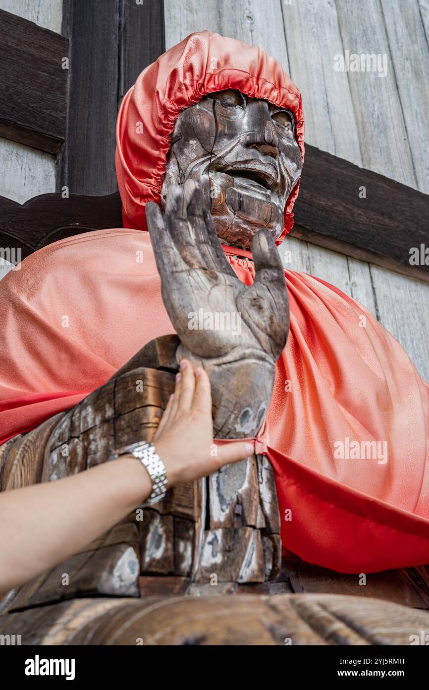 The wooden statue of Binzuru (Pindola Bharadvaja) at the entrance of ...