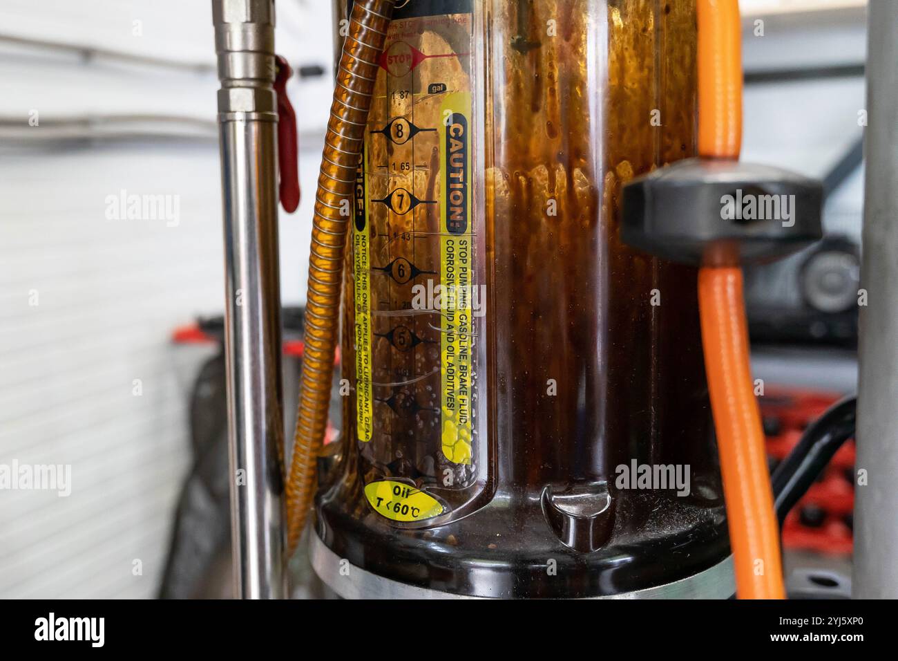 a container for vacuum pumping of used engine oil from a car engine ...