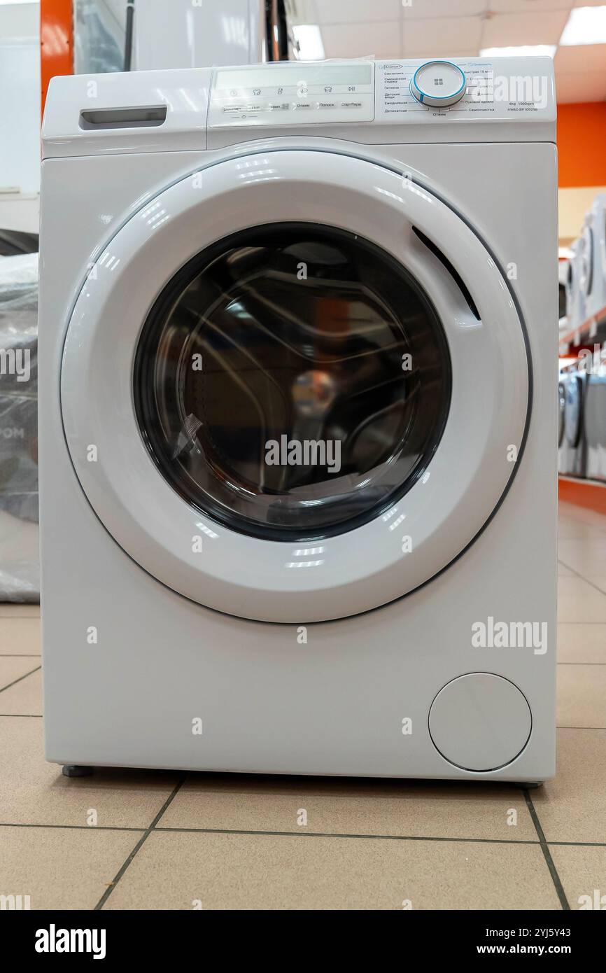 Front-loading washing machine showcased in a retail appliance store ...