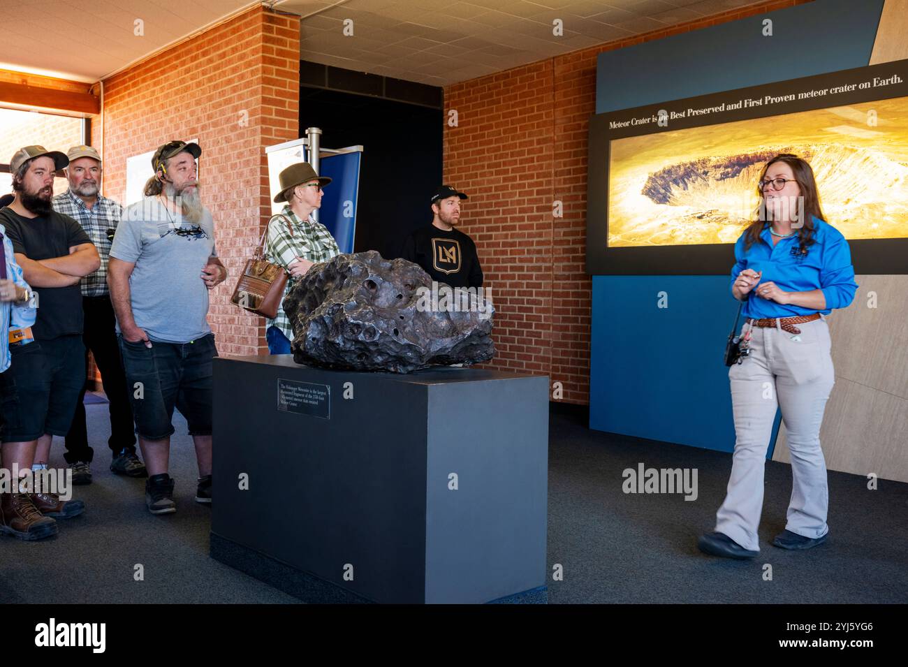Female tour guide speaking to visitors; Meteor Crater & Barringer Space ...
