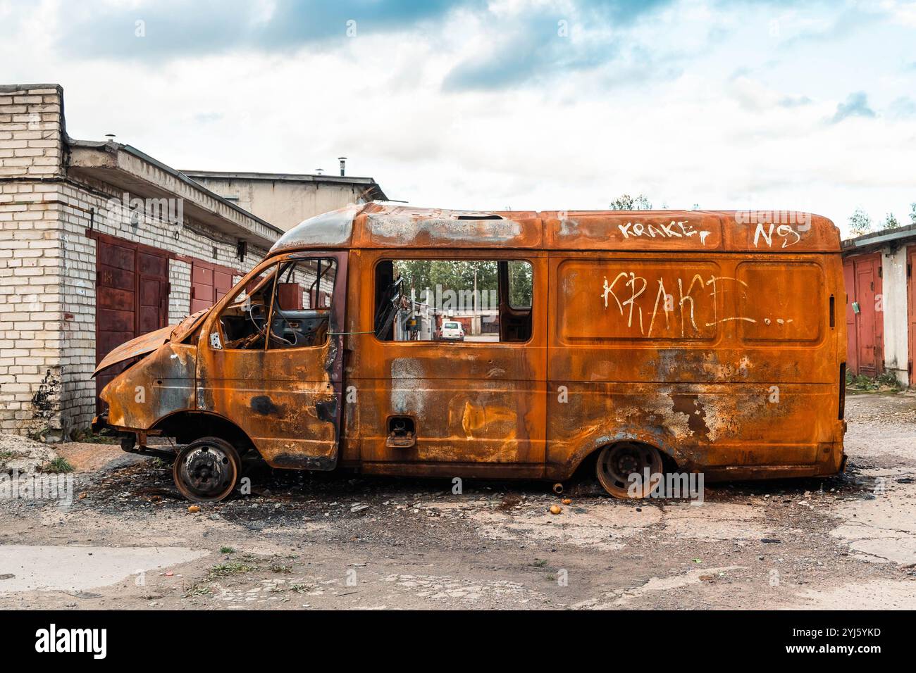 Rusty abandoned vandalized minivan covered with graffiti sitting on the ...