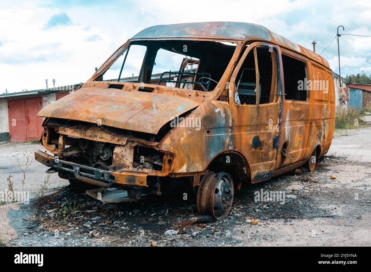Old rusty abandoned orange van sits with broken windows and a destroyed ...