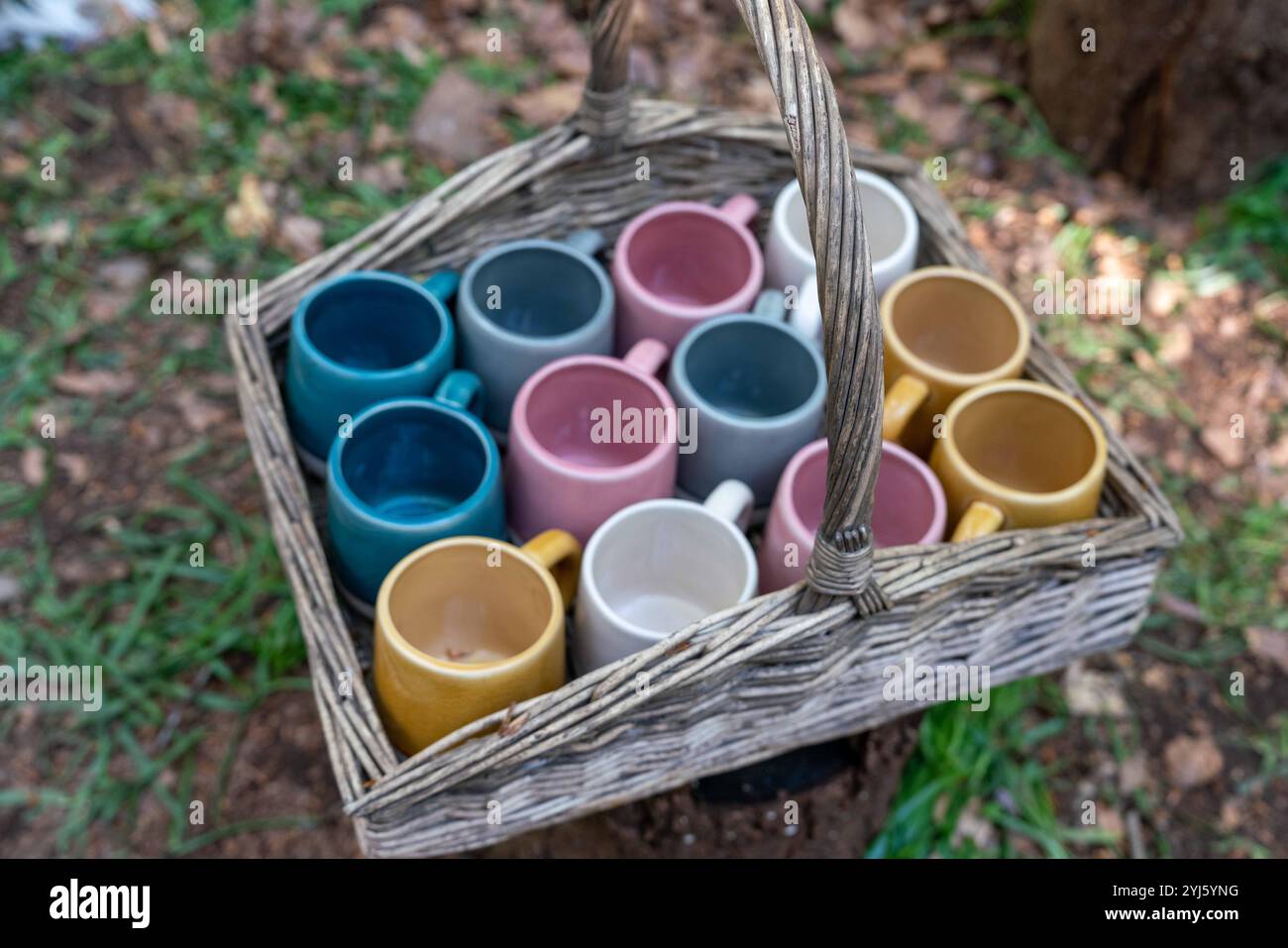 pastel coloured tea cups in a basket at an outside dinner Stock Photo ...