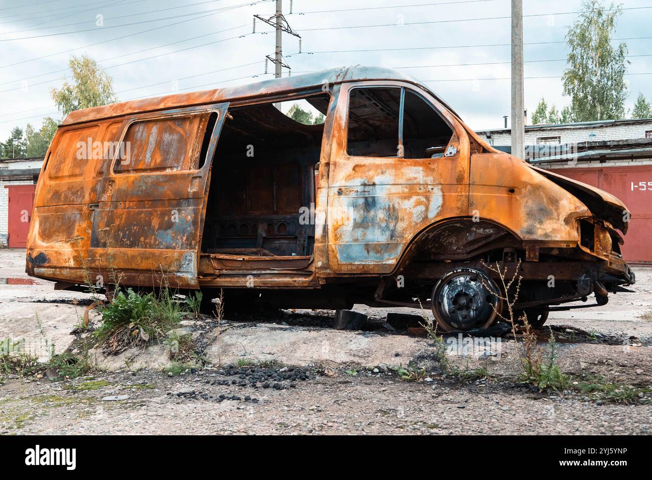 Rusty abandoned van sits decaying in an industrial junkyard, showcasing ...