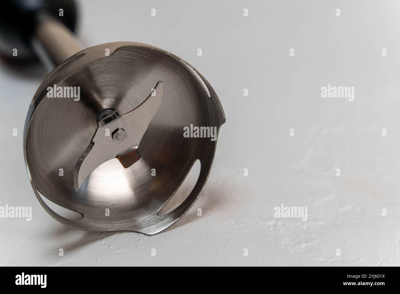 Stainless steel blender attachment resting on a light surface Stock ...