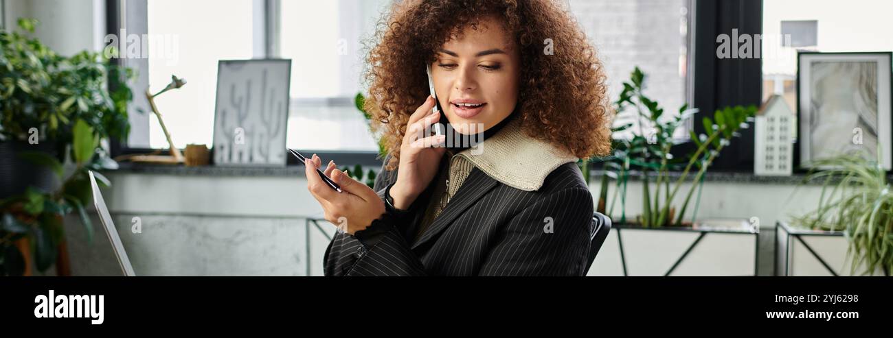 The woman smiles while engaged in a phone conversation, surrounded by ...