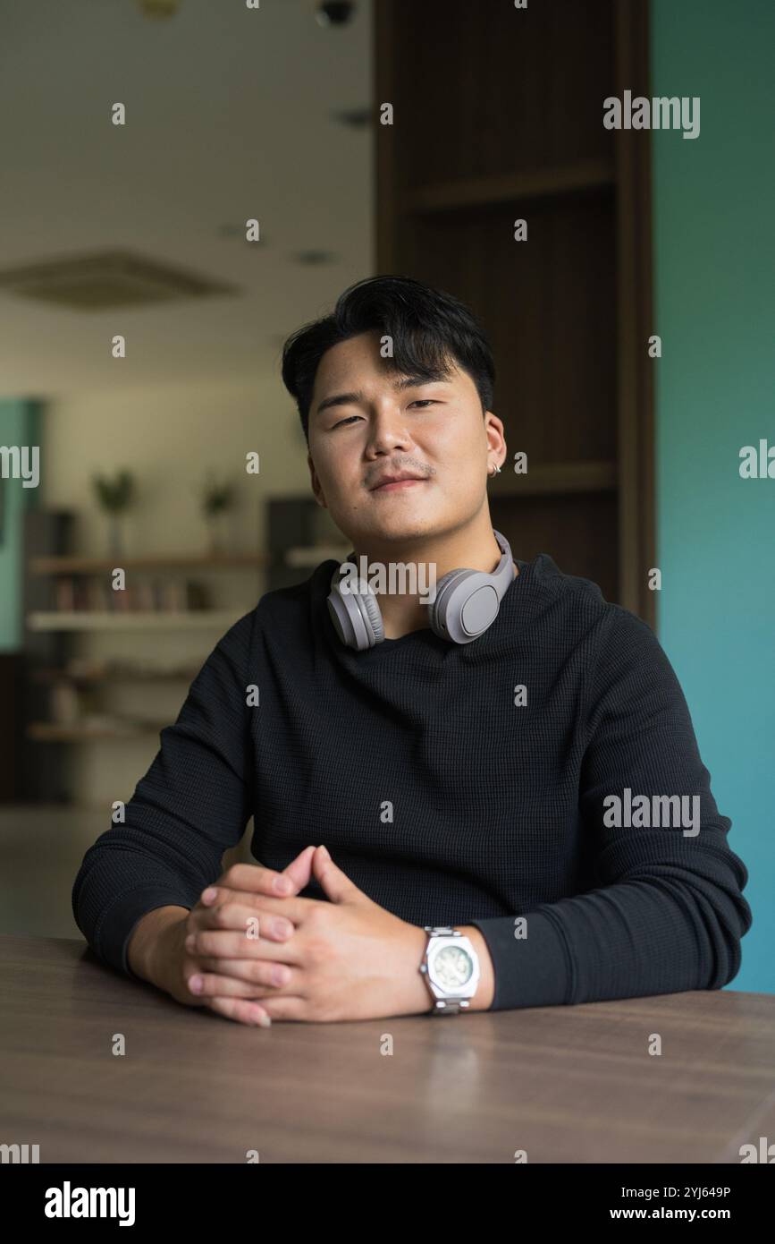 Happy asian man sitting hi-res stock photography and images - Alamy