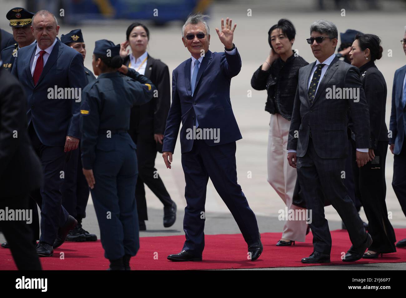 Taiwanese businessman and senior presidential advisor Lin Hsin-i waves after deplaning in Lima ...