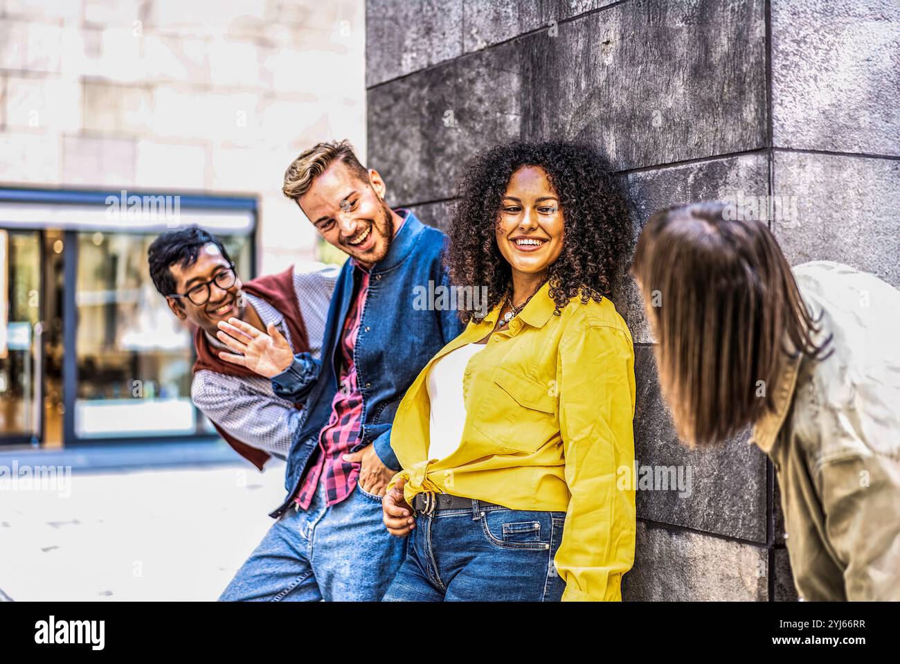 Group of diverse friends laughing and enjoying a fun moment outdoors ...