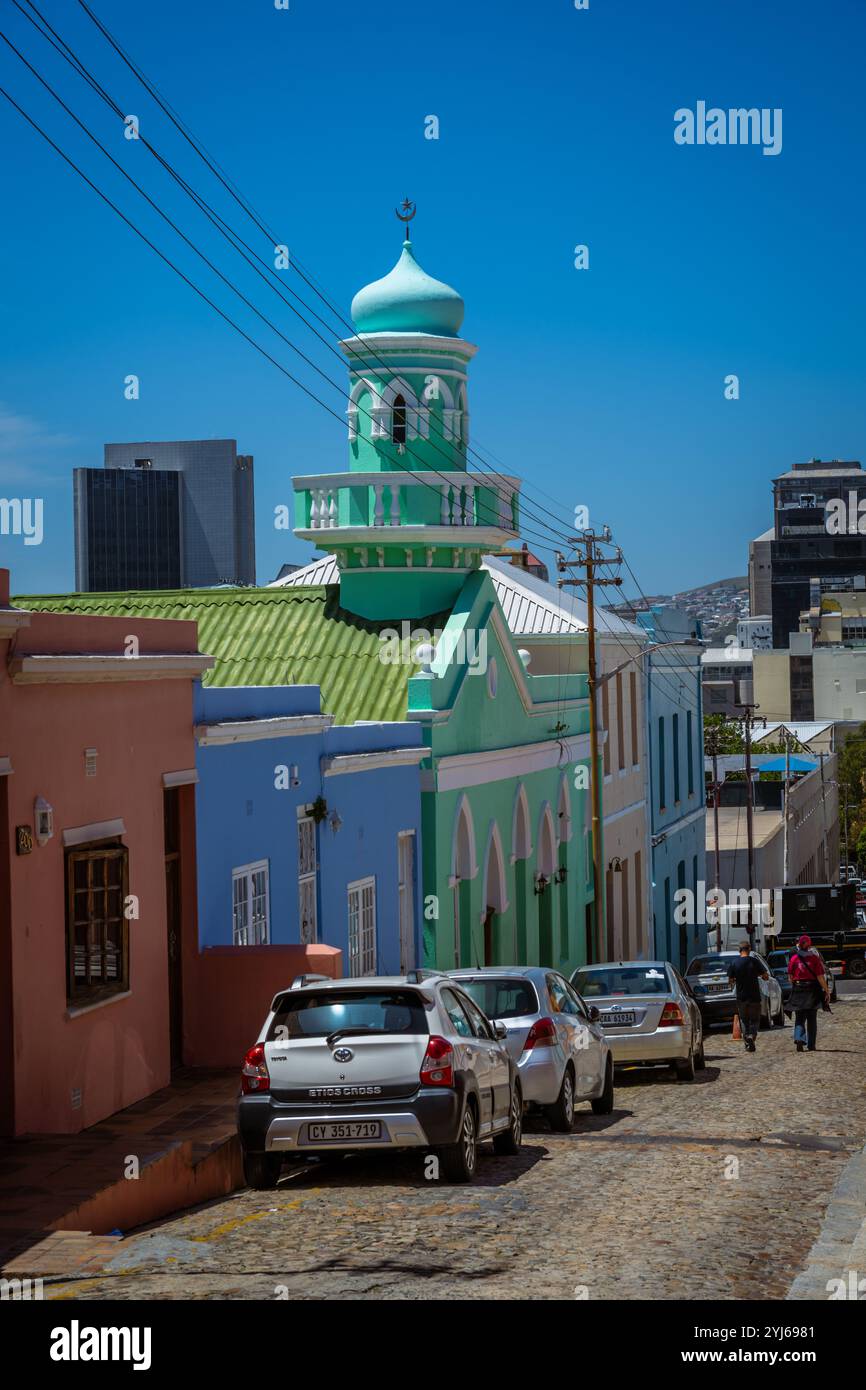 A green mosque minaret and colourful houses in Bo-Kaap quarter in Cape ...
