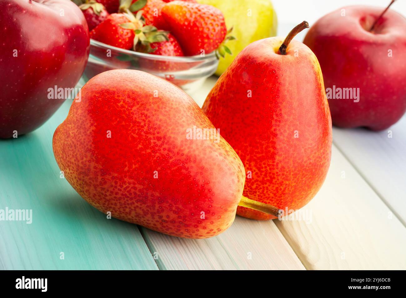 red pear on wood background Stock Photo - Alamy