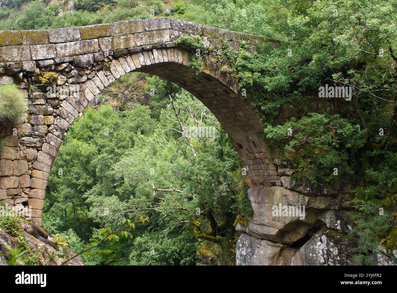 A very well preserved Roman-style arch bridge over a river. Misarela ...