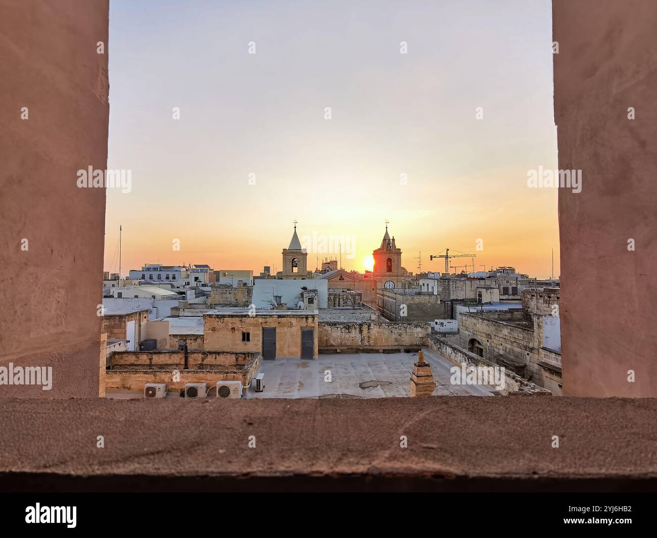 Sunrise over Valletta's rooftops, framing historic bell towers and ...