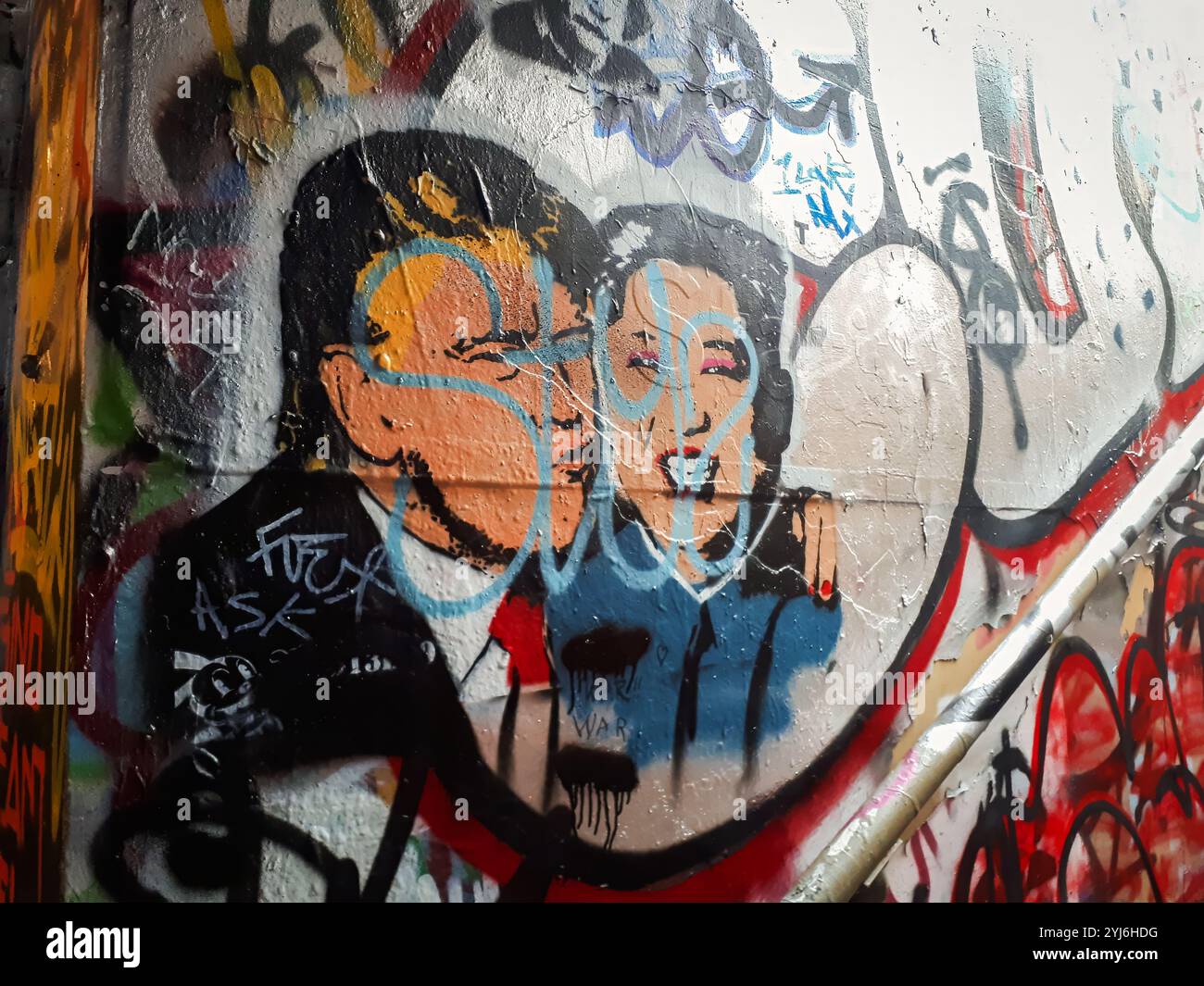 Graffiti art depicting two figures with vibrant colors and urban street ...