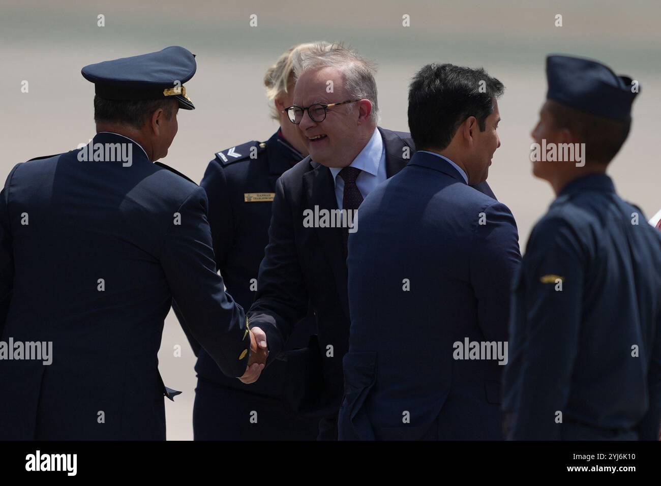 Australian Prime Minister Anthony Albanese, center, shakes hands with ...