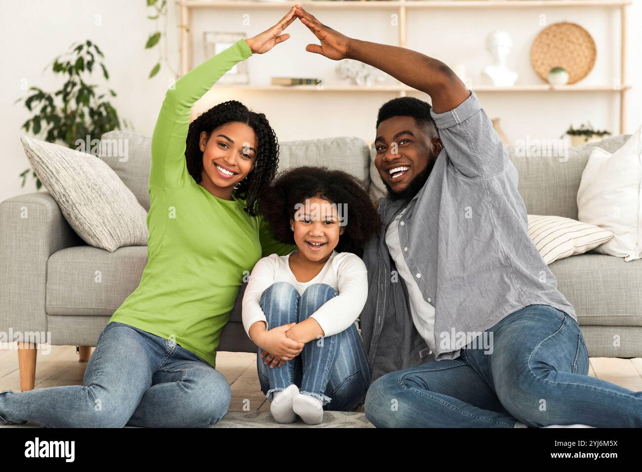Stay At Home Concept. Happy african parents making symbolic roof of ...