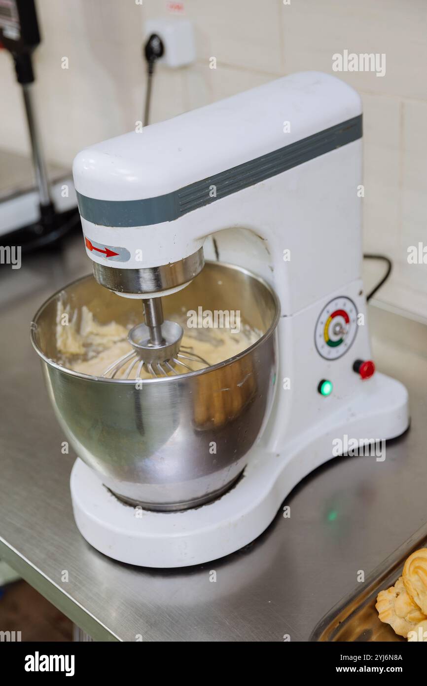 Professional stand mixer preparing dough for baking in a modern ...