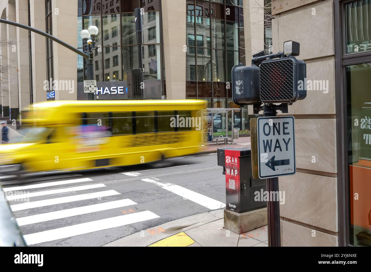 NASHVILLE, TN - 15 MAR 2024: Downtown street with moving yellow bus out ...