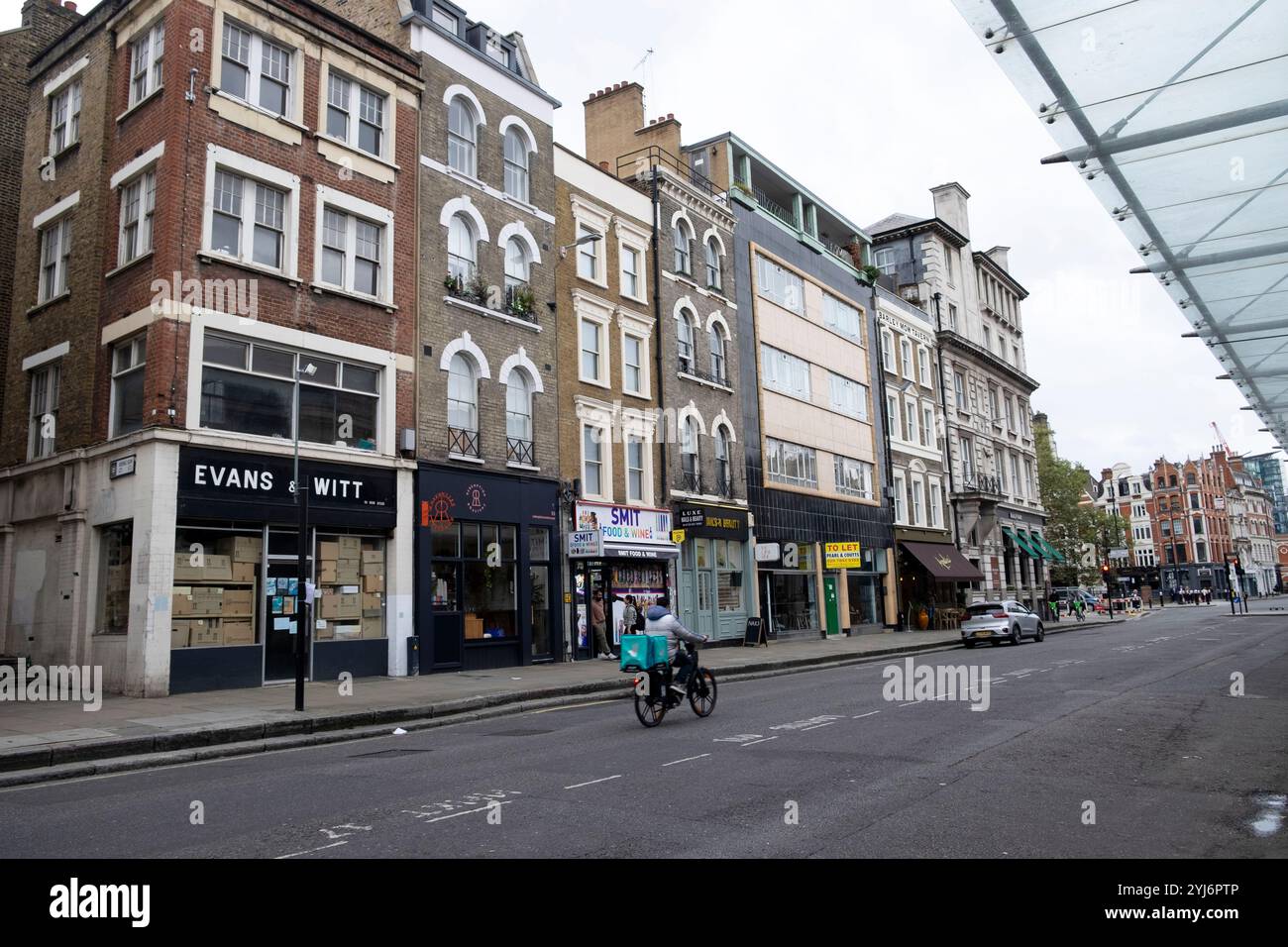 View of buildings, small shop, cafes on Long Lane empty street opposite ...