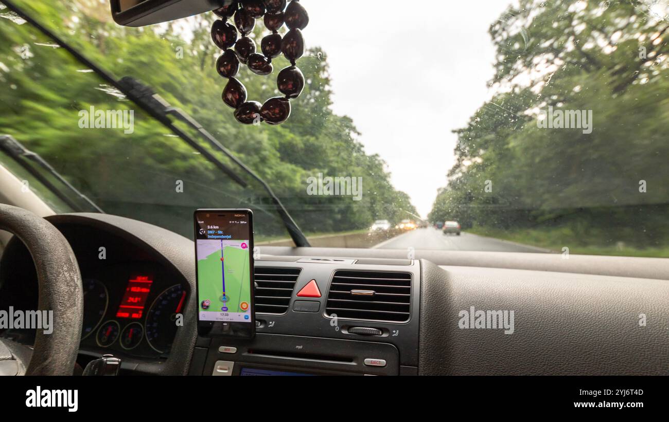 Smartphone showing Waze maps to show the way thru the city. Driver ...
